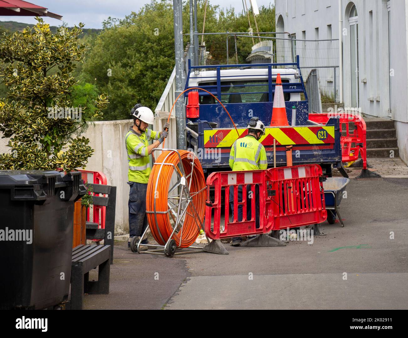 Engineers installing fibre optic cable underground Stock Photo - Alamy