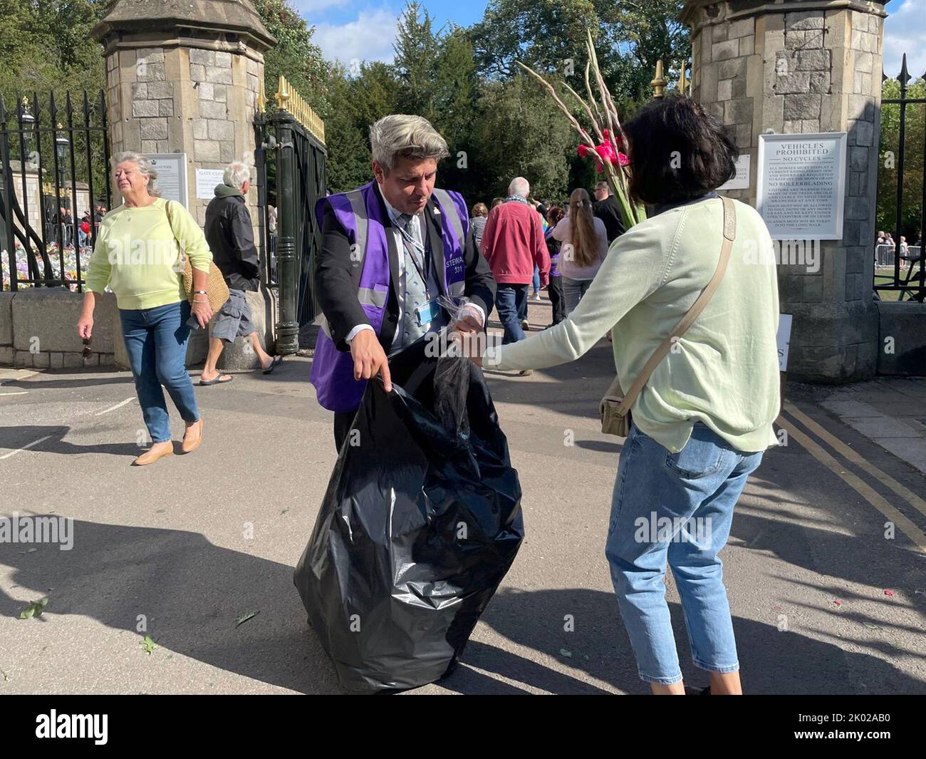 Steward Nick, 41, collecting the cellophane from the flowers of ...