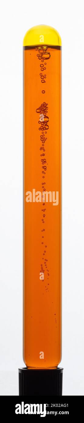 Yellow viscous liquid sunflower lecithin with bubbles in a transparent ...