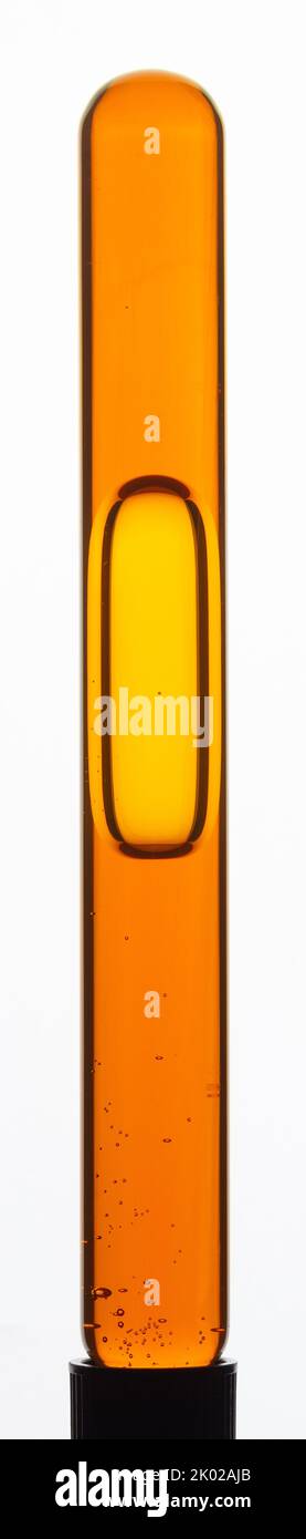 Yellow viscous liquid sunflower lecithin with bubbles in a transparent ...