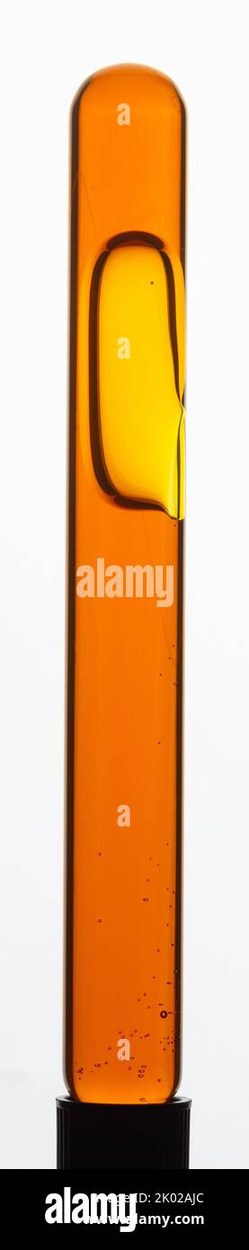 Yellow viscous liquid sunflower lecithin with bubbles in a transparent ...