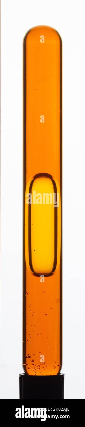 Yellow viscous liquid sunflower lecithin with bubbles in a transparent ...