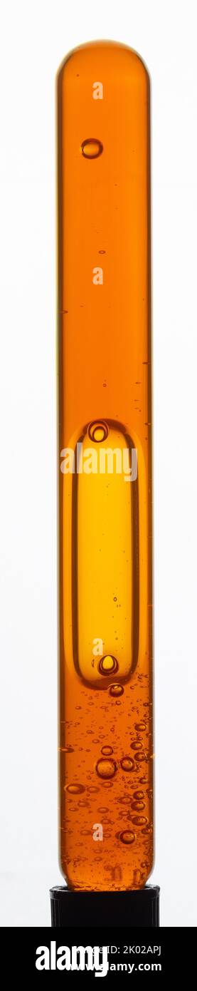 Yellow viscous liquid sunflower lecithin with bubbles in a transparent ...