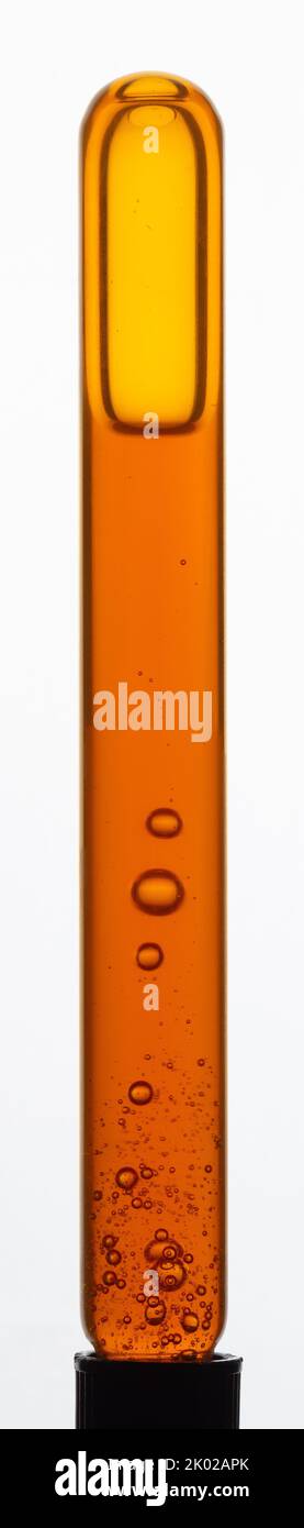Yellow viscous liquid sunflower lecithin with bubbles in a transparent ...