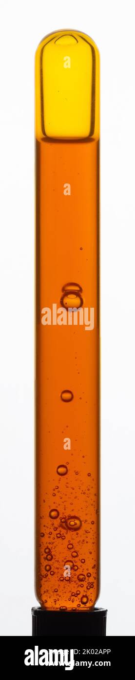 Yellow viscous liquid sunflower lecithin with bubbles in a transparent ...