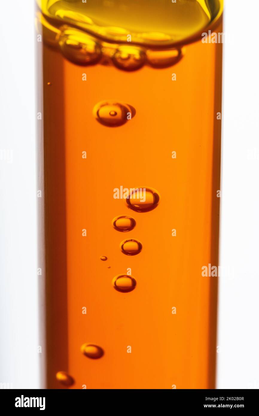 Yellow viscous liquid sunflower lecithin with bubbles in a transparent ...