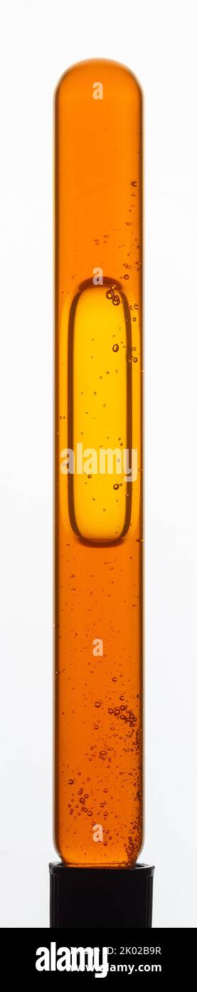 Yellow viscous liquid sunflower lecithin with bubbles in a transparent ...