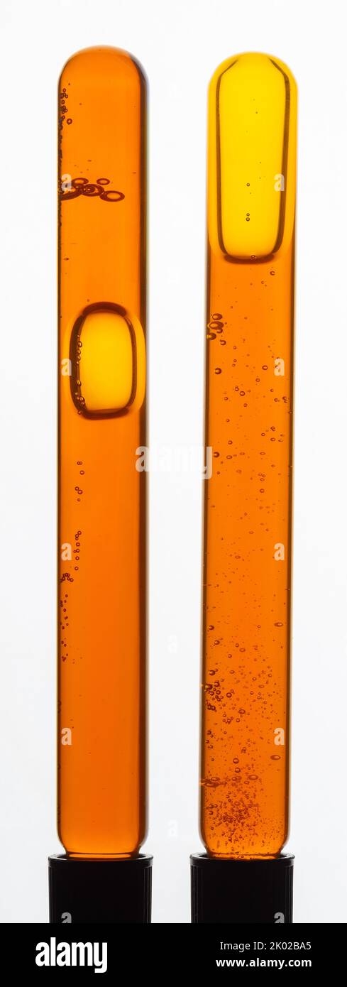 Yellow viscous liquid sunflower lecithin with bubbles in a transparent ...