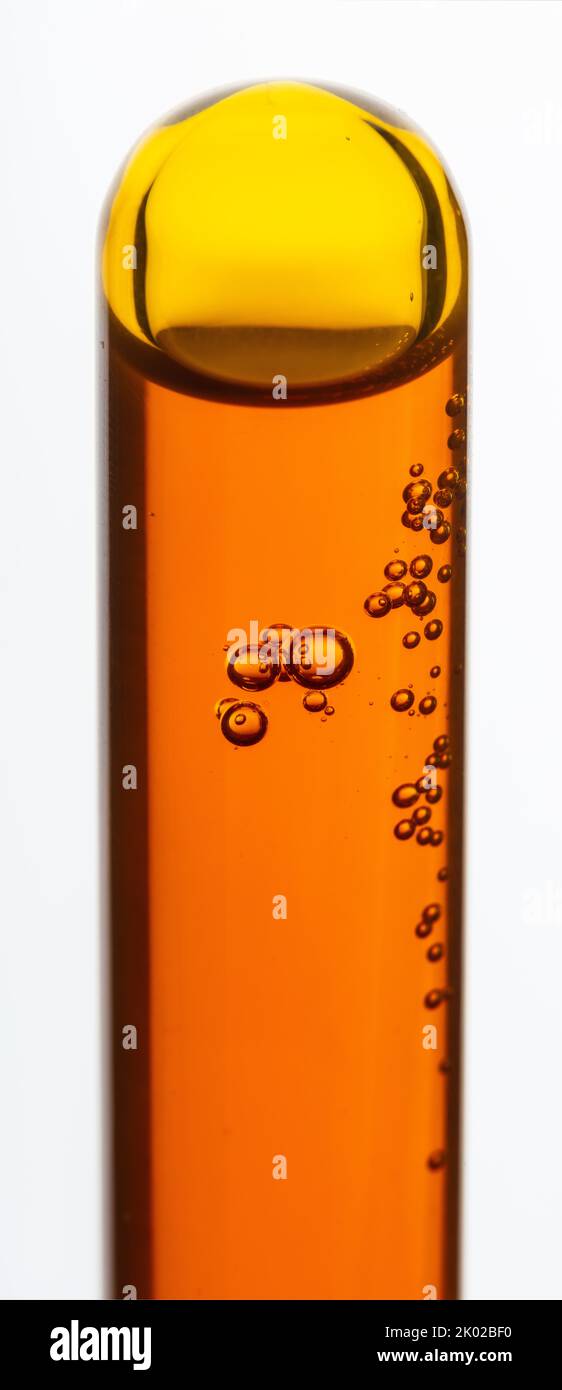 Yellow viscous liquid sunflower lecithin with bubbles in a transparent ...