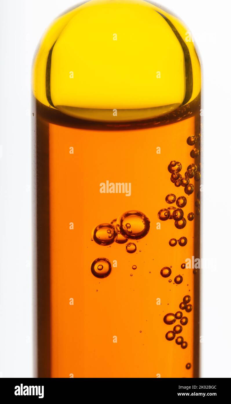 Yellow viscous liquid sunflower lecithin with bubbles in a transparent ...