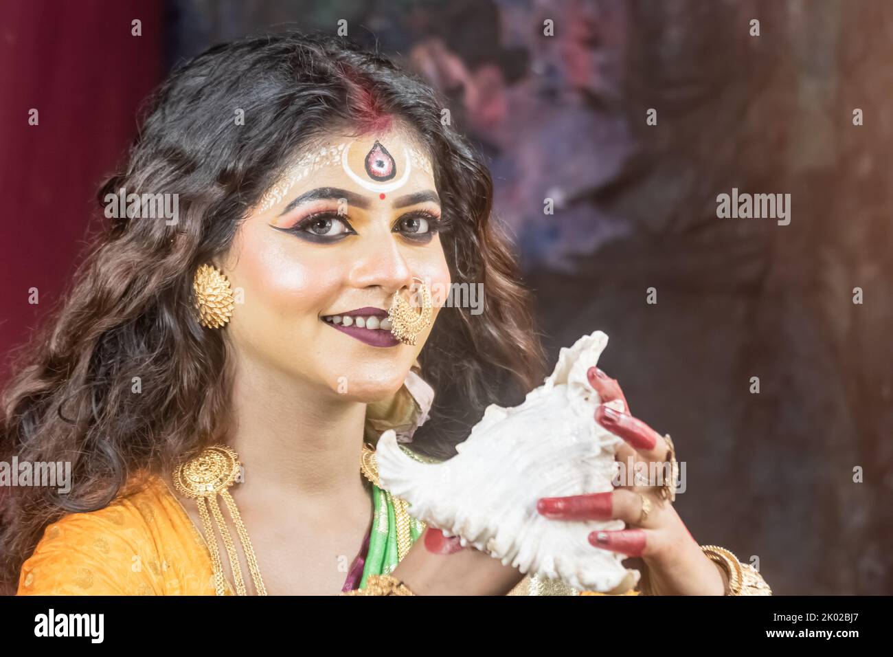 Concept Agomoni shoot with black haired Indian brunette woman face with ...