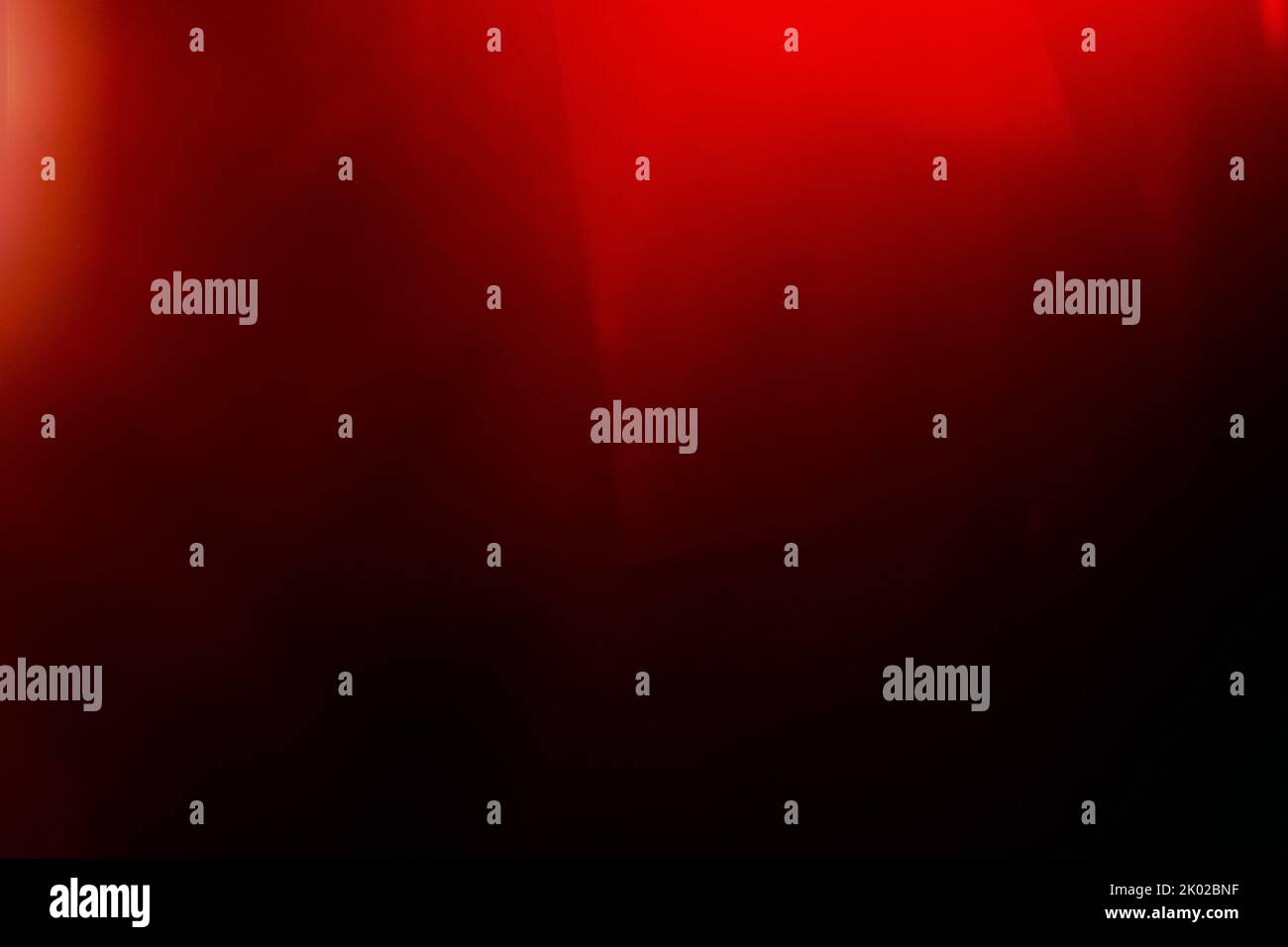 red overlay lens flare effect defocused glow dark Stock Photo - Alamy