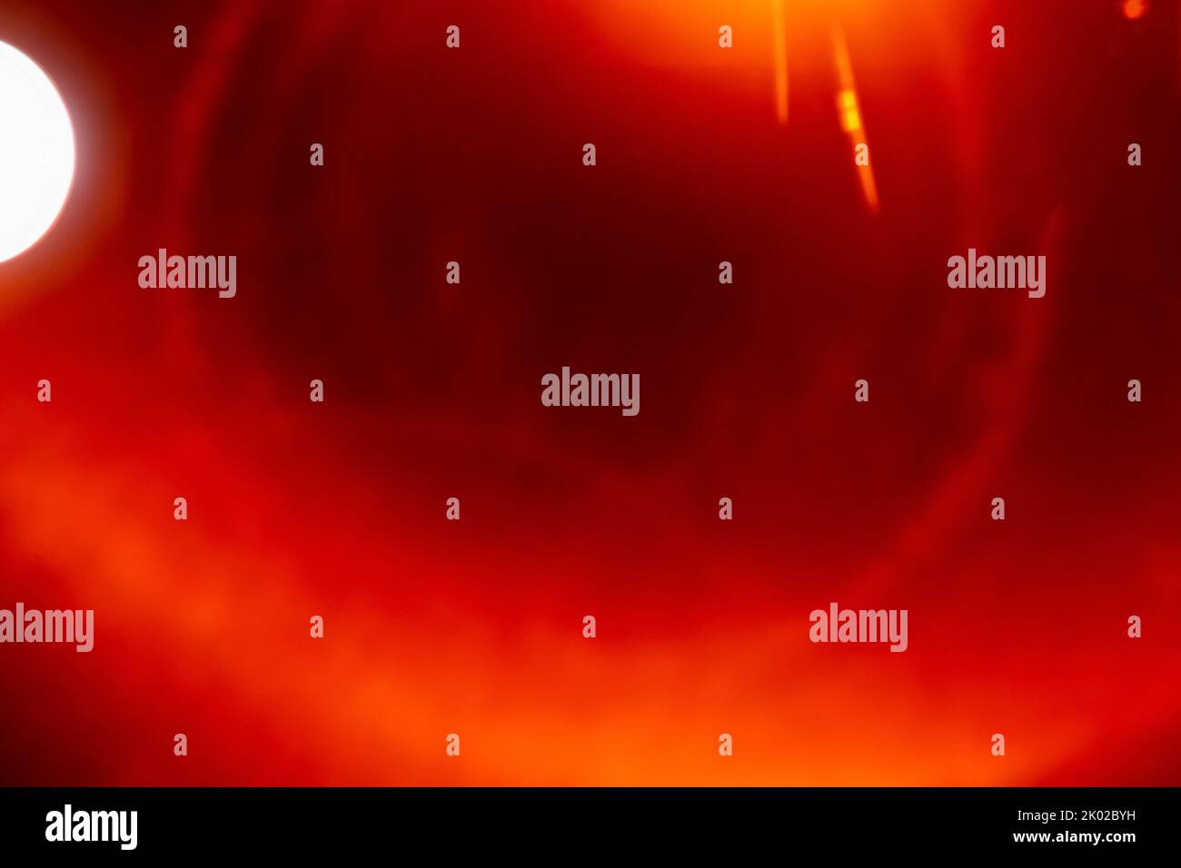 red abstract background lens flare blur rays white Stock Photo - Alamy