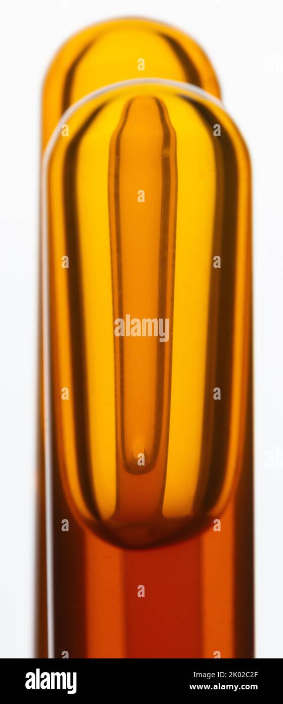 Yellow viscous liquid sunflower lecithin with bubbles in a transparent ...