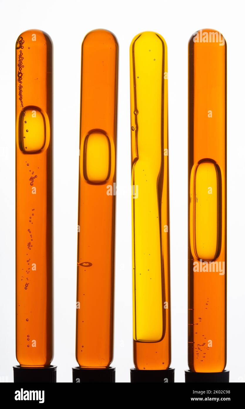 Yellow viscous liquid sunflower lecithin with bubbles in a transparent ...