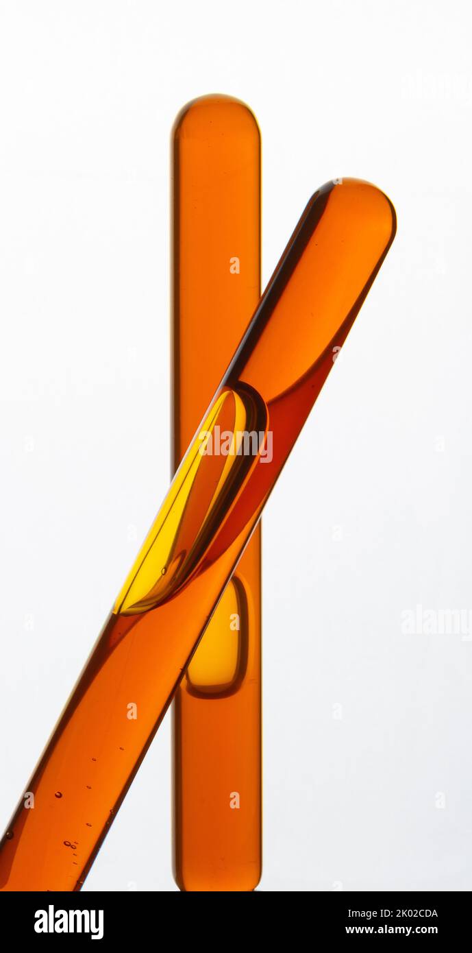 Yellow viscous liquid sunflower lecithin with bubbles in a transparent ...