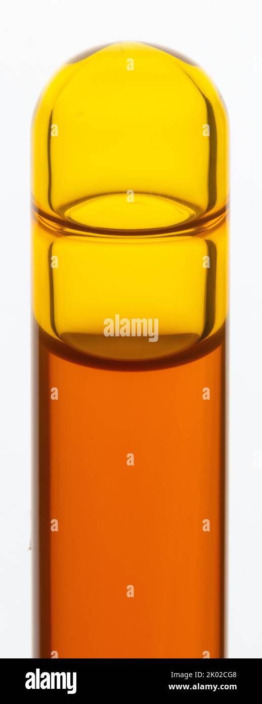 Yellow viscous liquid sunflower lecithin with bubbles in a transparent ...