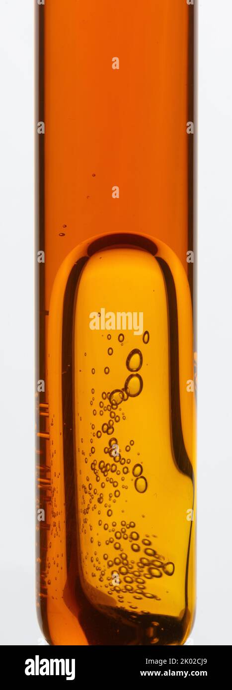 Yellow viscous liquid sunflower lecithin with bubbles in a transparent ...