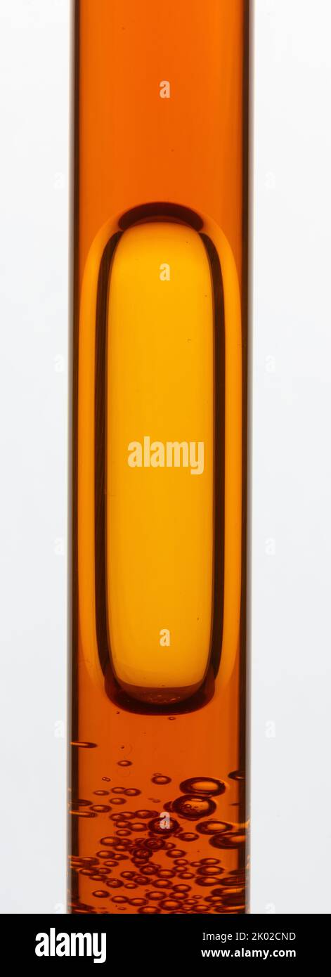 Yellow viscous liquid sunflower lecithin with bubbles in a transparent ...