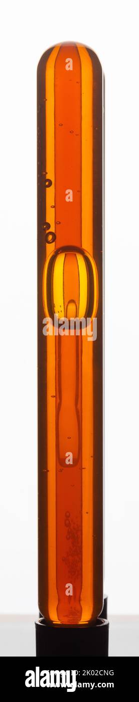 Yellow viscous liquid sunflower lecithin with bubbles in a transparent ...