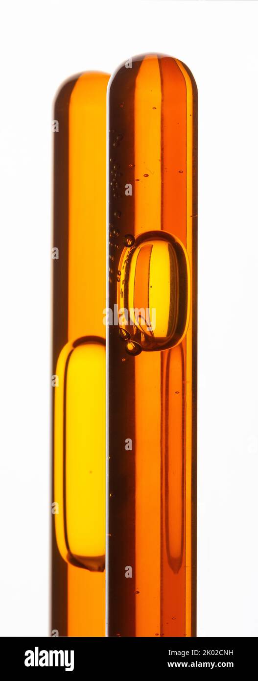 Yellow viscous liquid sunflower lecithin with bubbles in a transparent ...