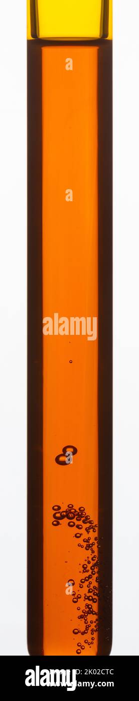 Yellow viscous liquid sunflower lecithin with bubbles in a transparent ...