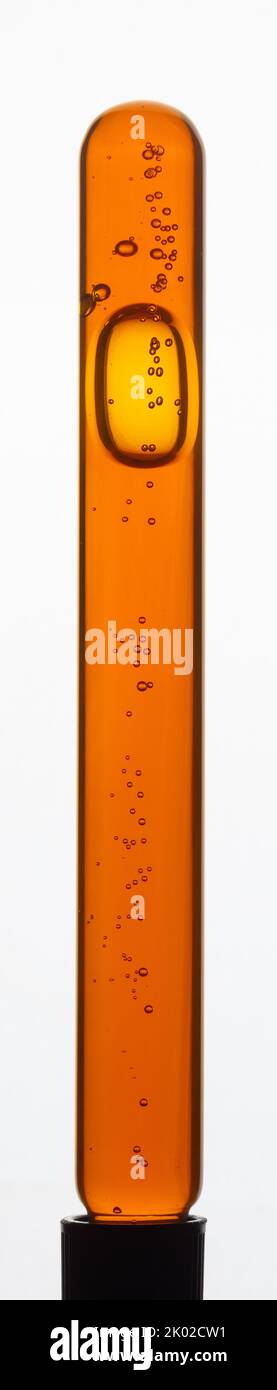 Yellow viscous liquid sunflower lecithin with bubbles in a transparent ...