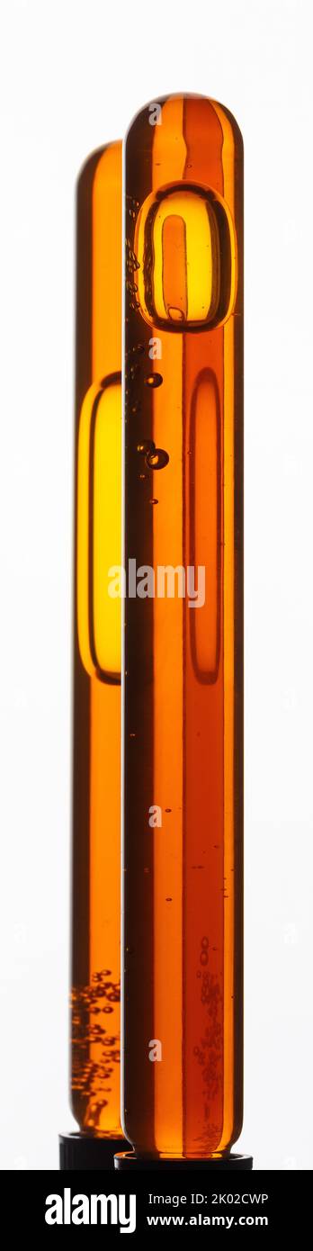 Yellow viscous liquid sunflower lecithin with bubbles in a transparent ...