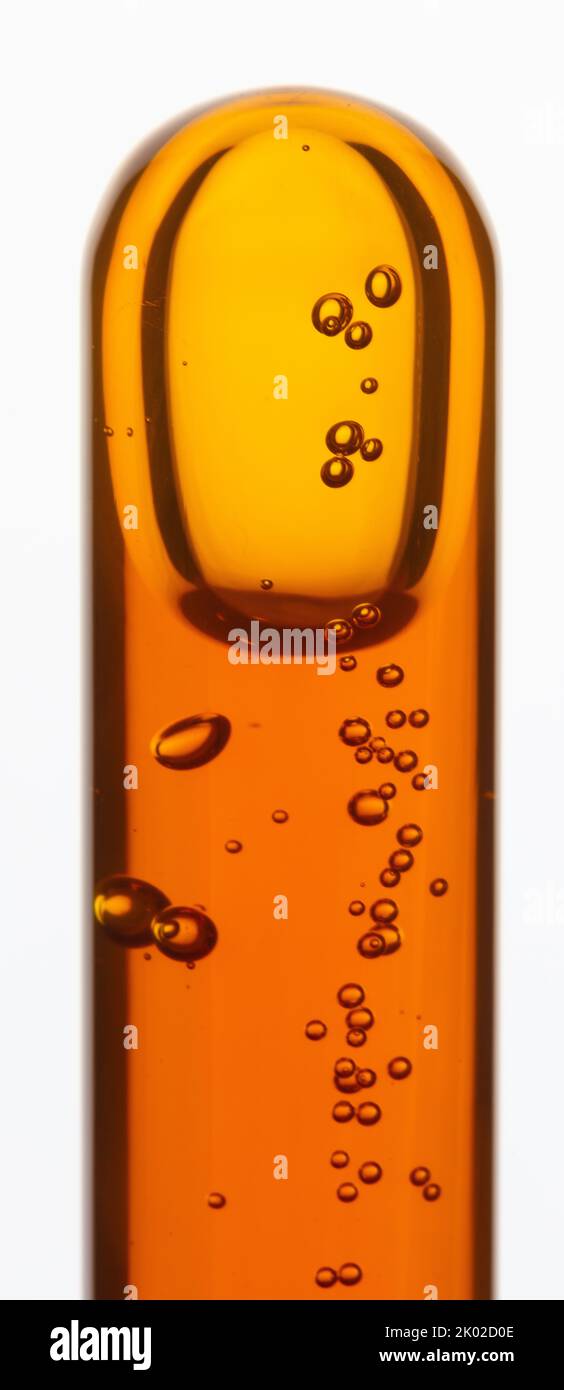 Yellow viscous liquid sunflower lecithin with bubbles in a transparent ...