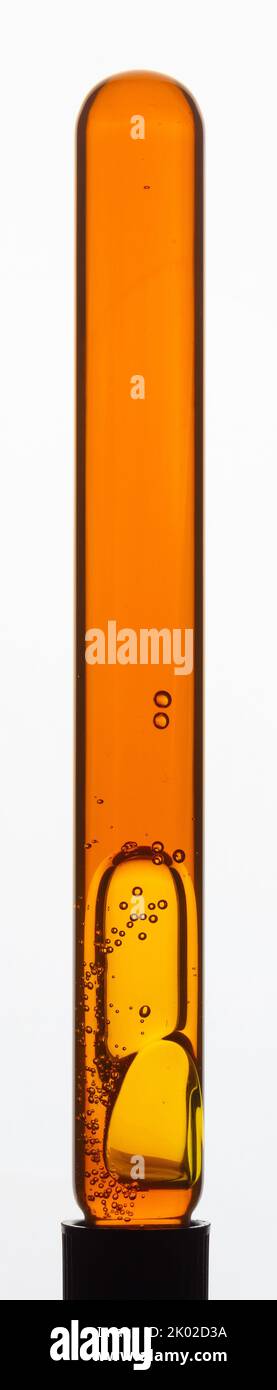 Yellow viscous liquid sunflower lecithin with bubbles in a transparent ...