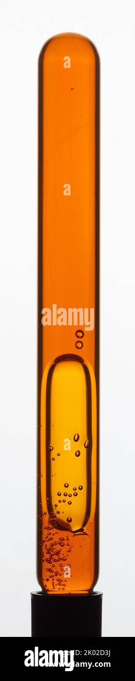 Yellow viscous liquid sunflower lecithin with bubbles in a transparent ...