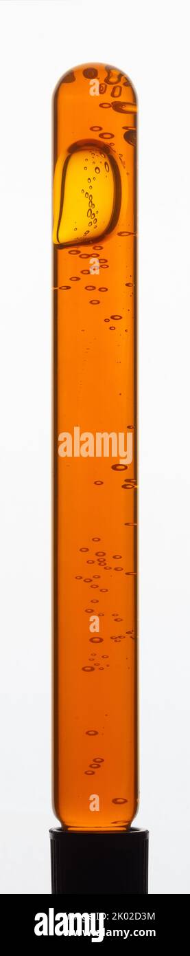 Yellow viscous liquid sunflower lecithin with bubbles in a transparent ...