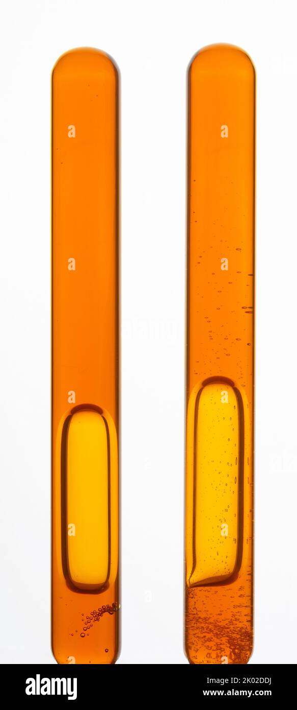 Yellow viscous liquid sunflower lecithin with bubbles in a transparent ...