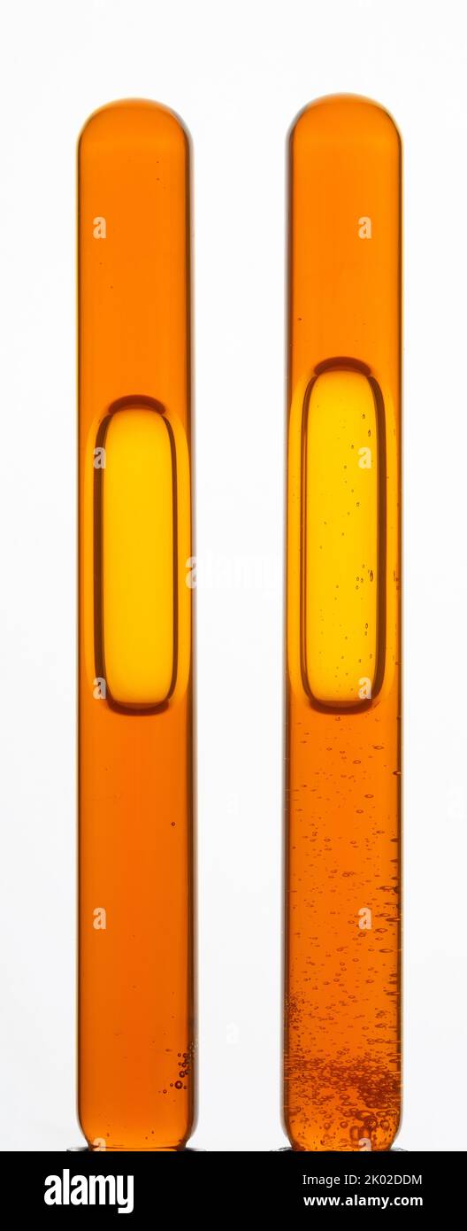 Yellow viscous liquid sunflower lecithin with bubbles in a transparent ...