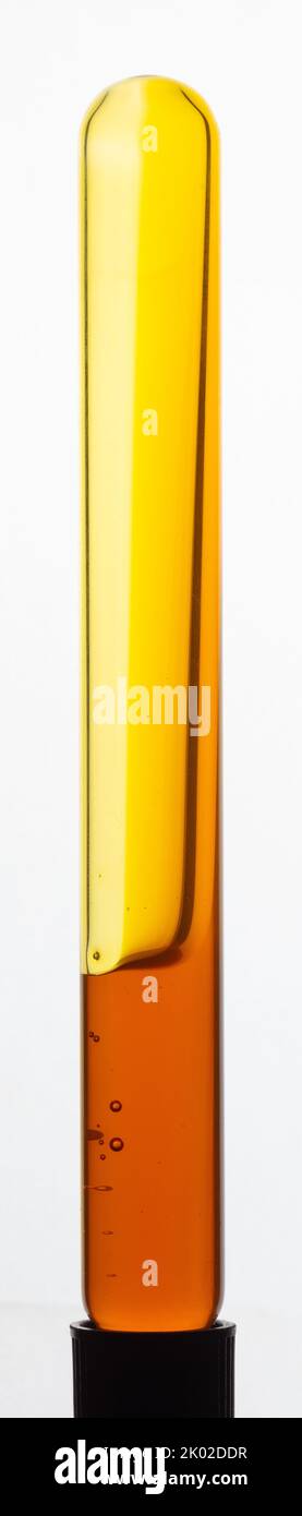 Yellow viscous liquid sunflower lecithin with bubbles in a transparent ...