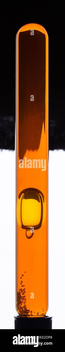 Yellow viscous liquid sunflower lecithin with bubbles in a transparent ...