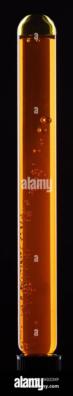 Yellow viscous liquid sunflower lecithin with bubbles in a transparent ...