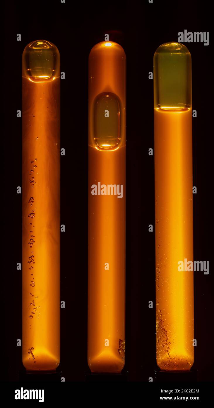Yellow viscous liquid sunflower lecithin with bubbles in a transparent ...