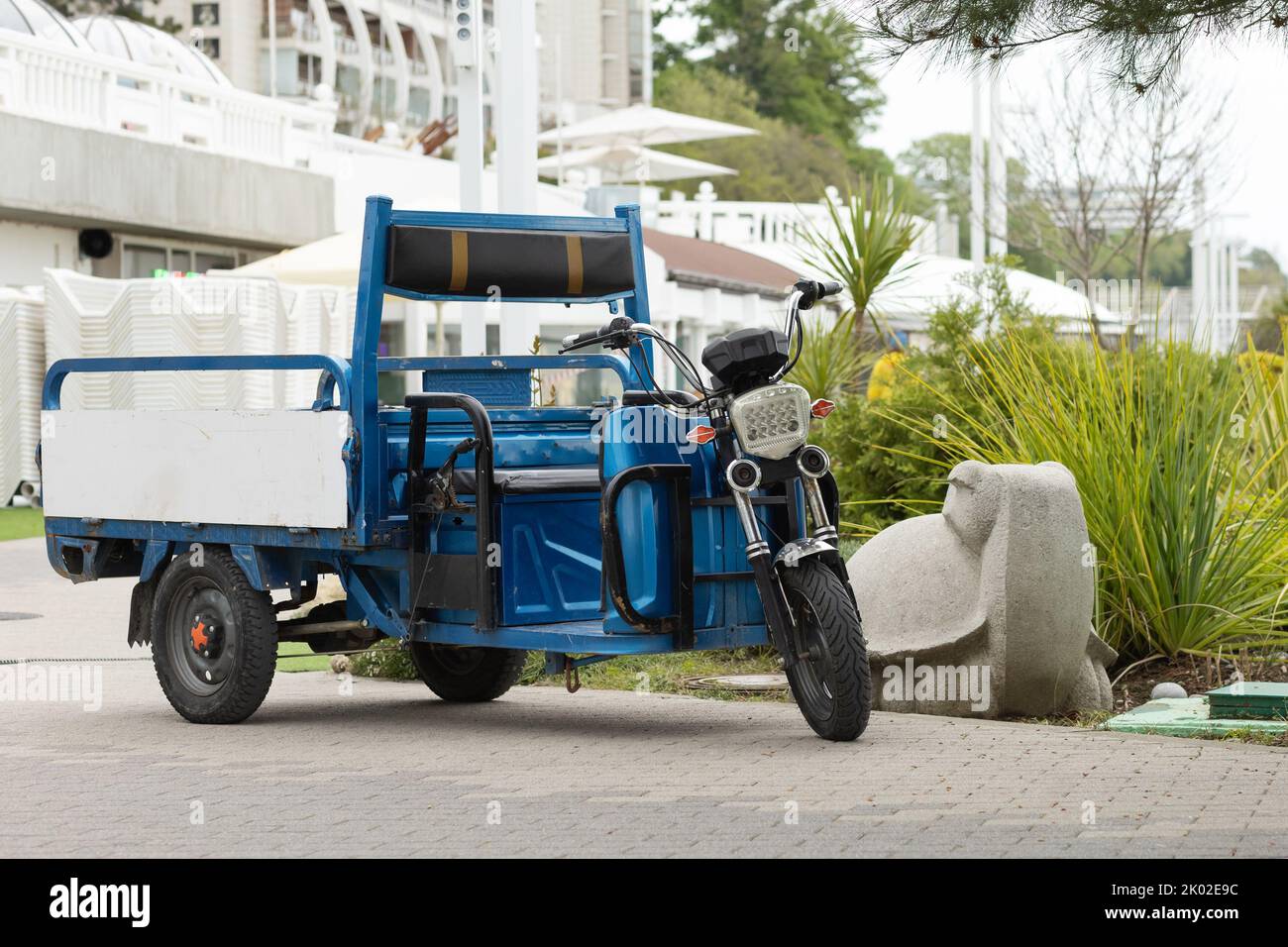 Three wheel electric scooter. Moped with a body stands on street Stock ...
