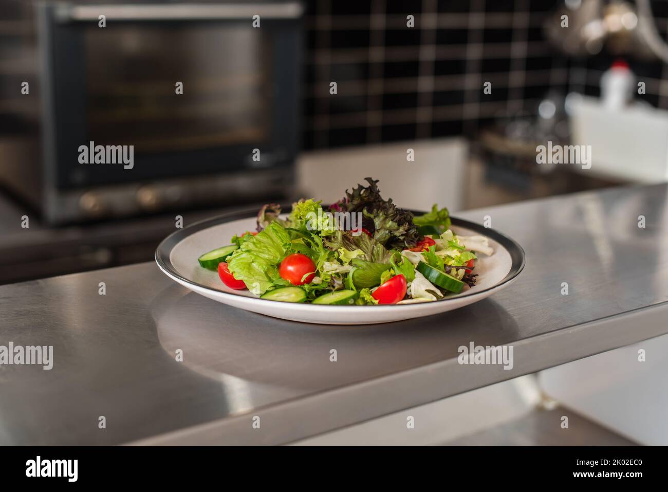 plate with freshly cooked salad in professional kitchen,stock image ...