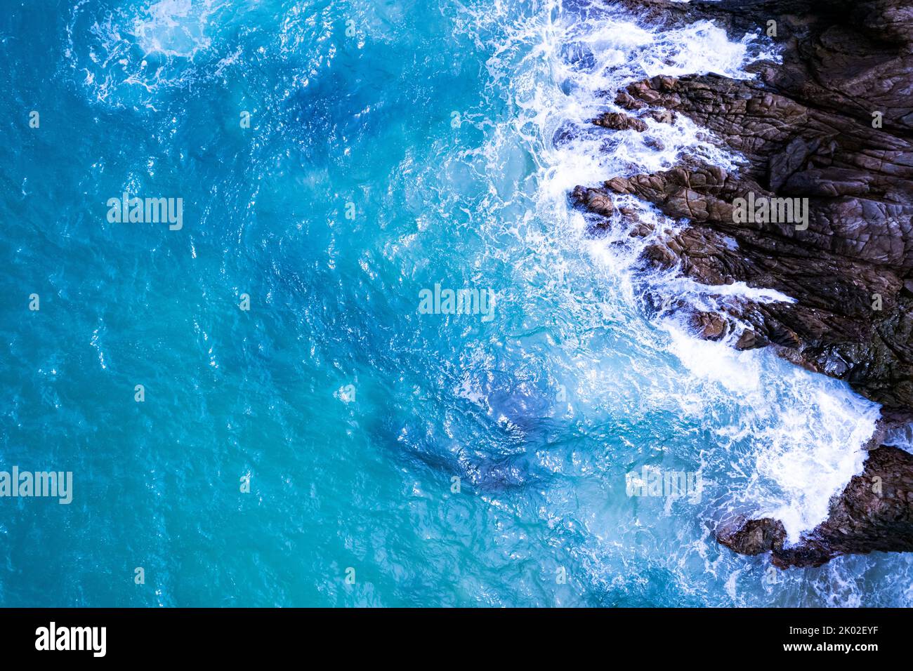 Aerial view of sea crashing waves White foaming waves on seashore rocks ...