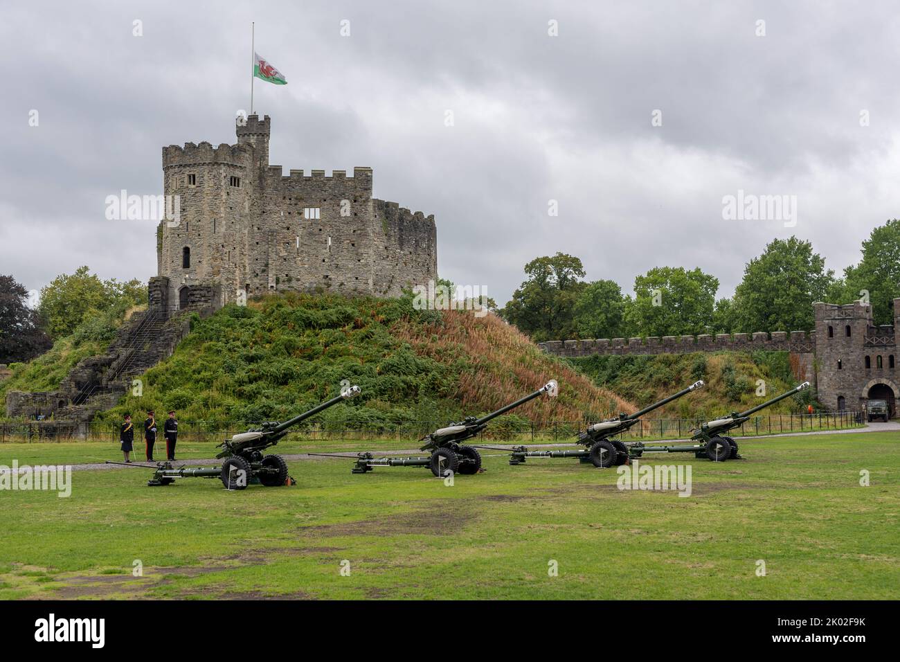 The Welsh flag at half mast as soldiers fire a 96 gun salute at Cardiff ...
