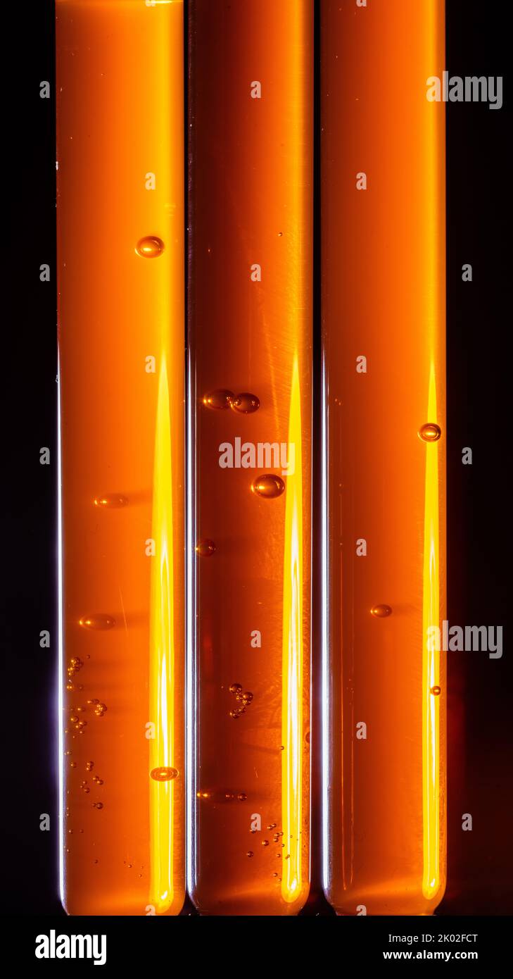 Yellow viscous liquid sunflower lecithin with bubbles in a transparent ...