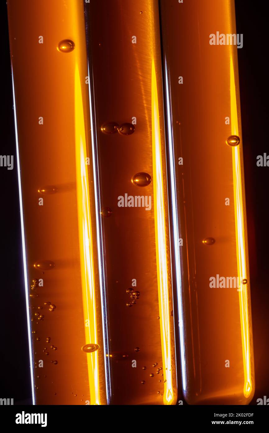 Yellow viscous liquid sunflower lecithin with bubbles in a transparent ...