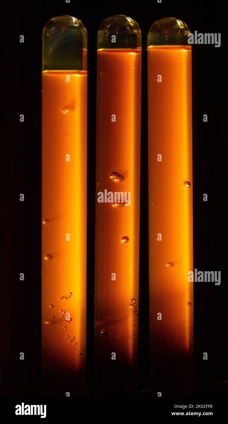 Yellow viscous liquid sunflower lecithin with bubbles in a transparent ...
