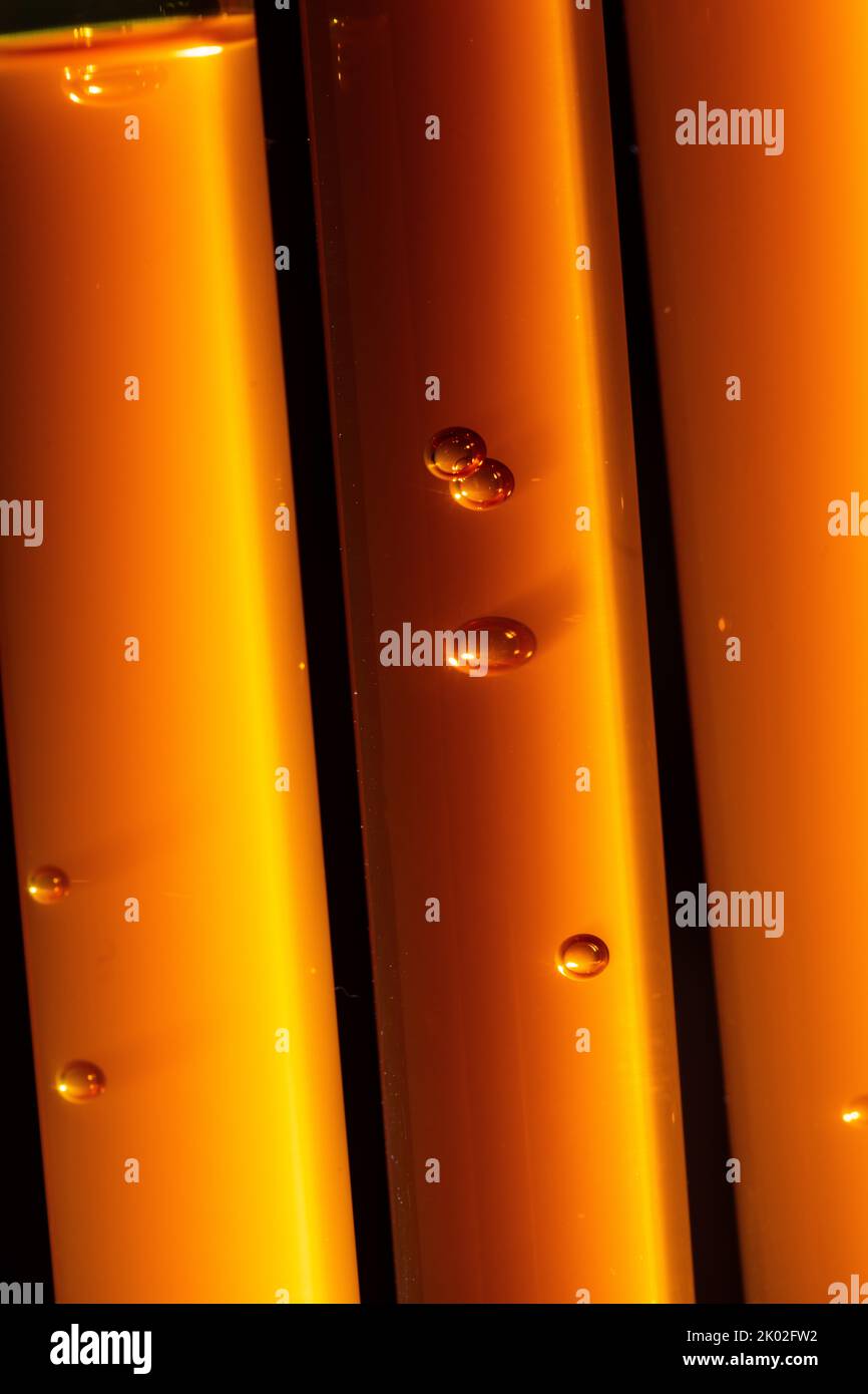 Yellow viscous liquid sunflower lecithin with bubbles in a transparent ...