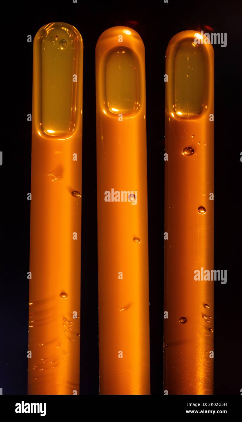 Yellow viscous liquid sunflower lecithin with bubbles in a transparent ...