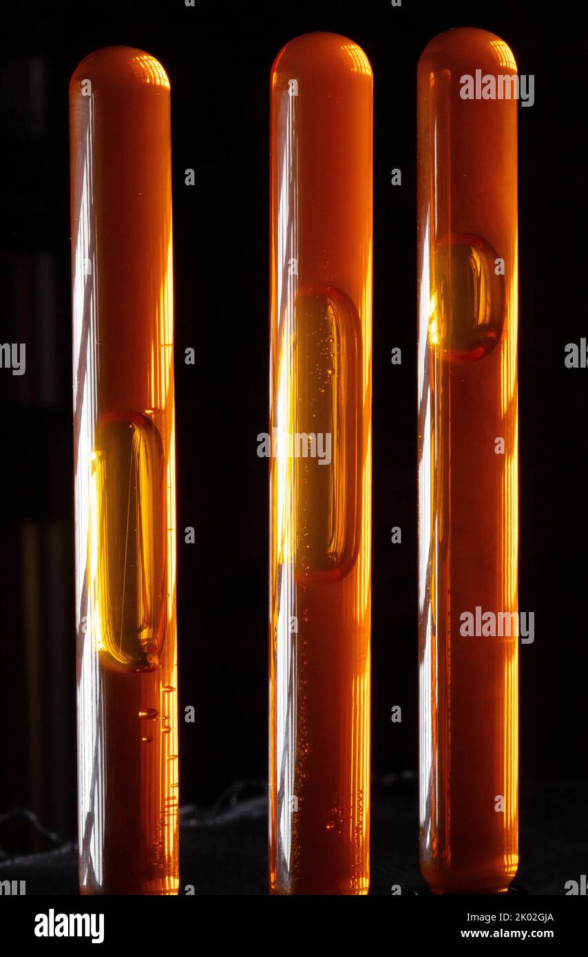 Yellow viscous liquid sunflower lecithin with bubbles in a transparent ...