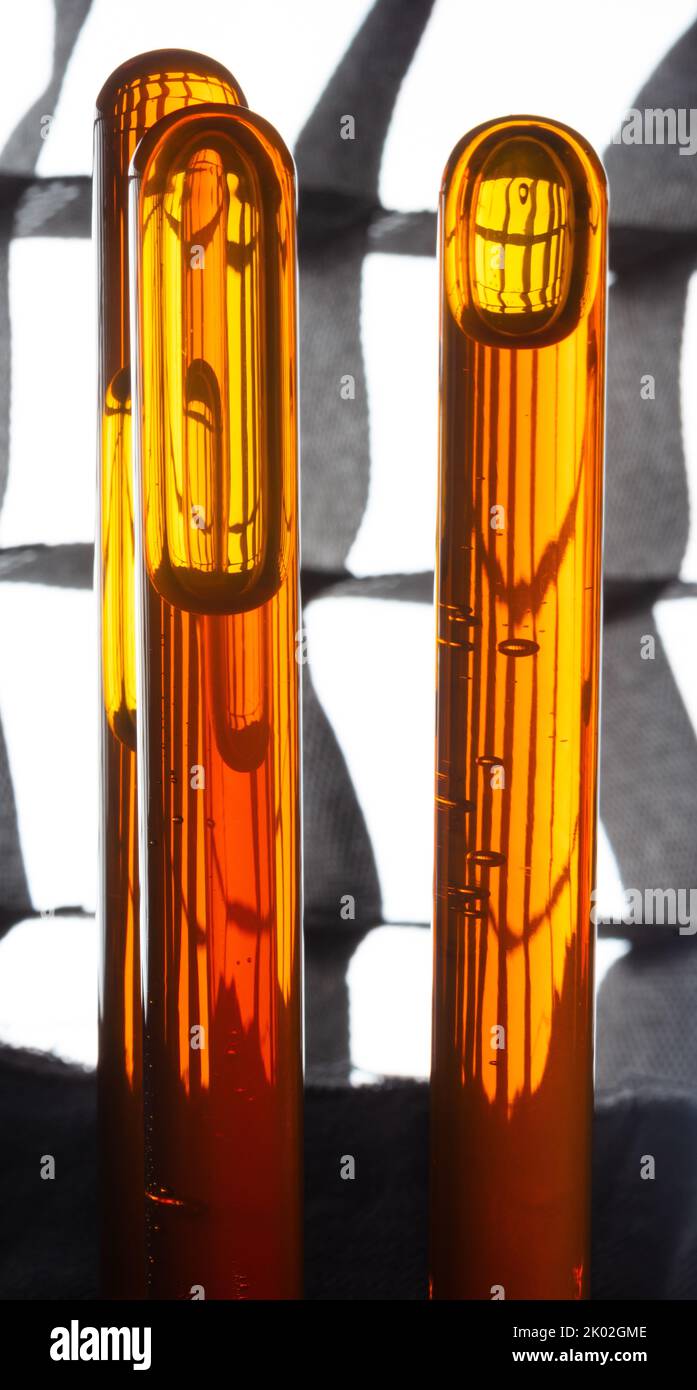 Yellow viscous liquid sunflower lecithin with bubbles in a transparent ...