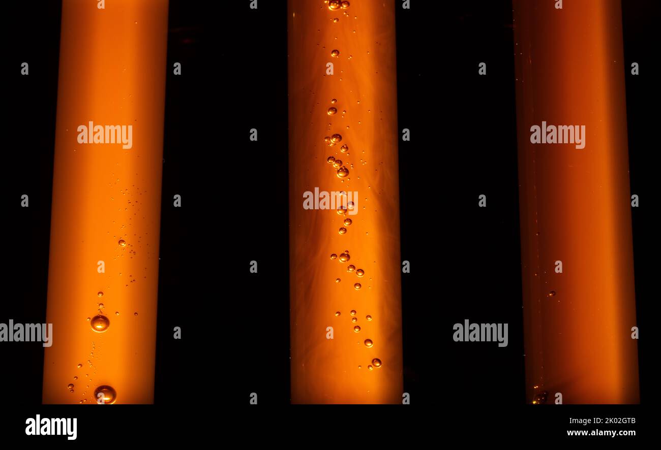 Yellow viscous liquid sunflower lecithin with bubbles in a transparent ...